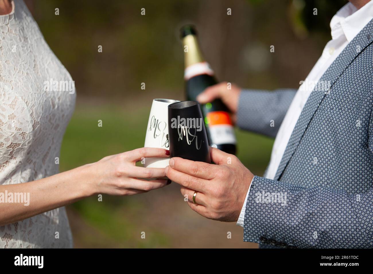 A bride and a groom toast their marriage with personalized engraved ...