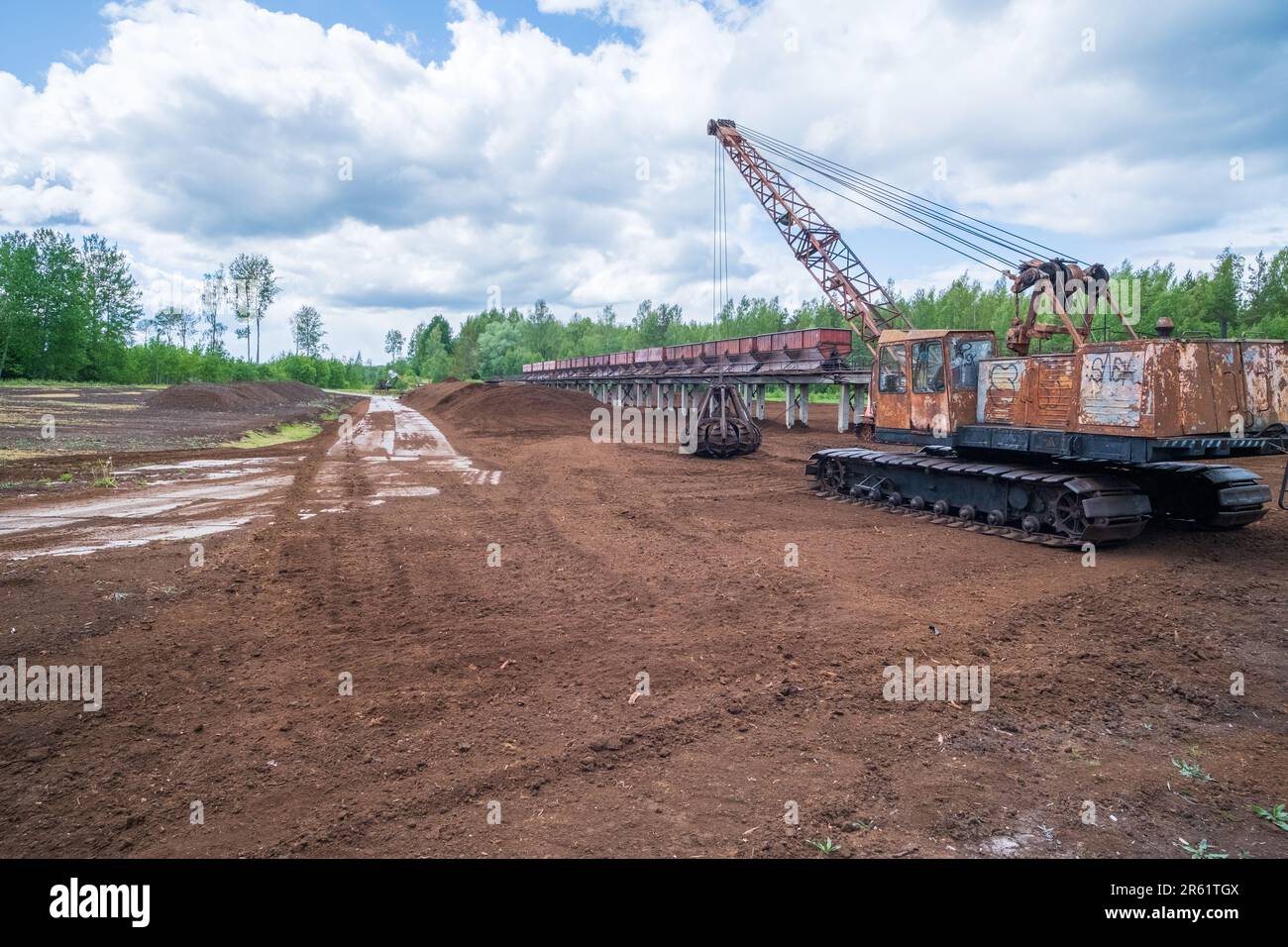 Excavator for stacking peat. Large dome bucket for loading into train ...