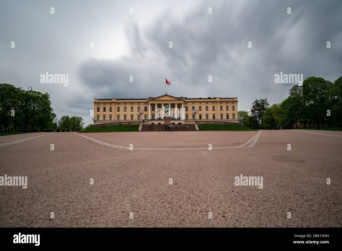 The Royal Palace in Oslo among lush greenery and a plush lawn, creating ...