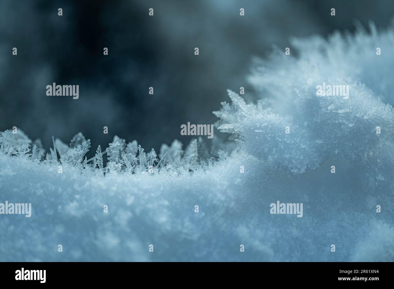 A close-up shot of an icy window pane, the frosty glass sparkling in ...