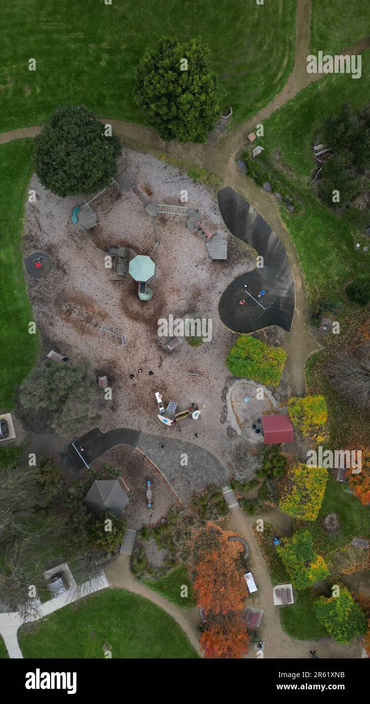 An aerial view of a lush hillside park, featuring green lawns, trees ...