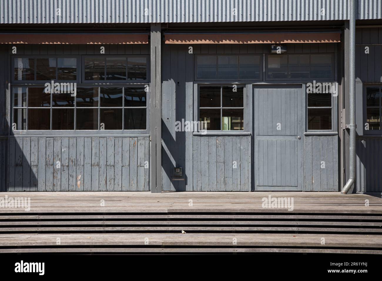 A grand gray structure with two access points and a balcony featuring ...