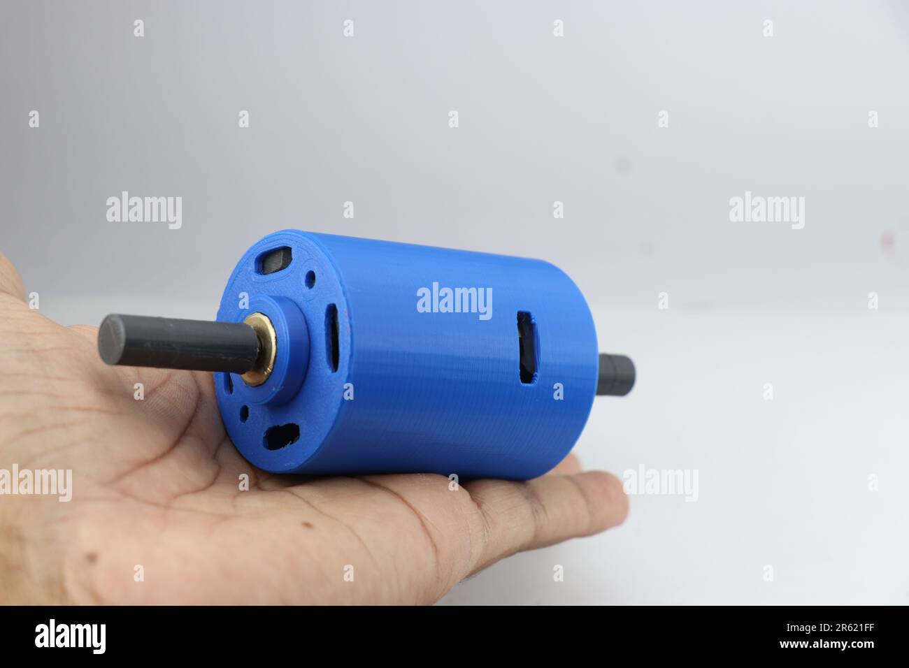 3D printed dc motor with dual shaft made from PLA filament held in the ...