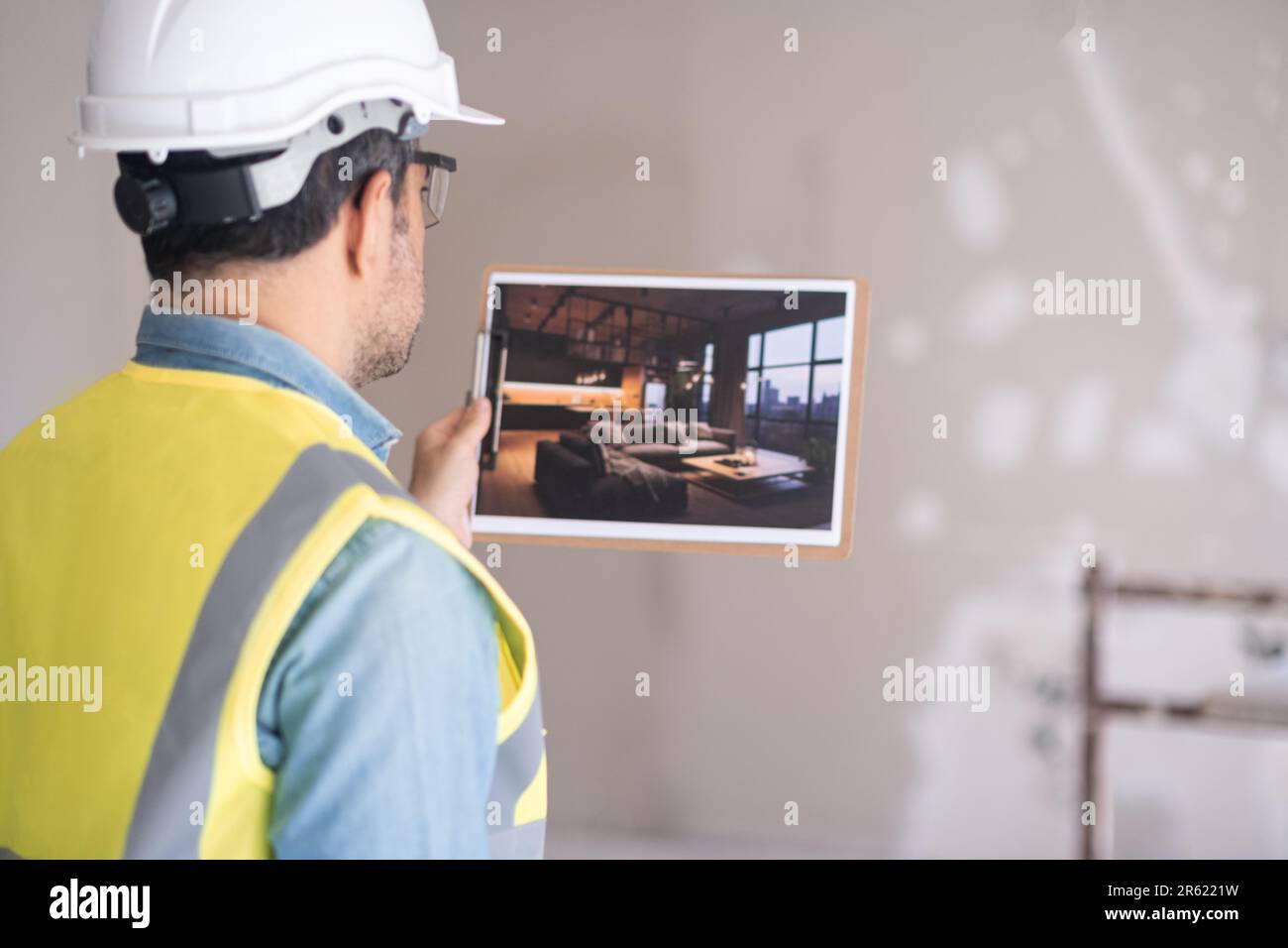 Professional engineer looking at picture with modern living room design ...