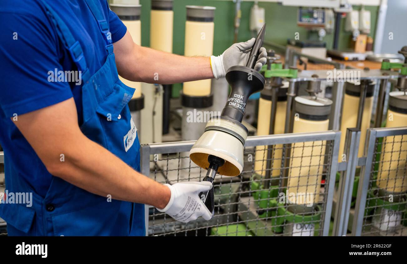 06 June 2023, Lower Saxony, Unterlüß: An employee holds parts of a 120 ...