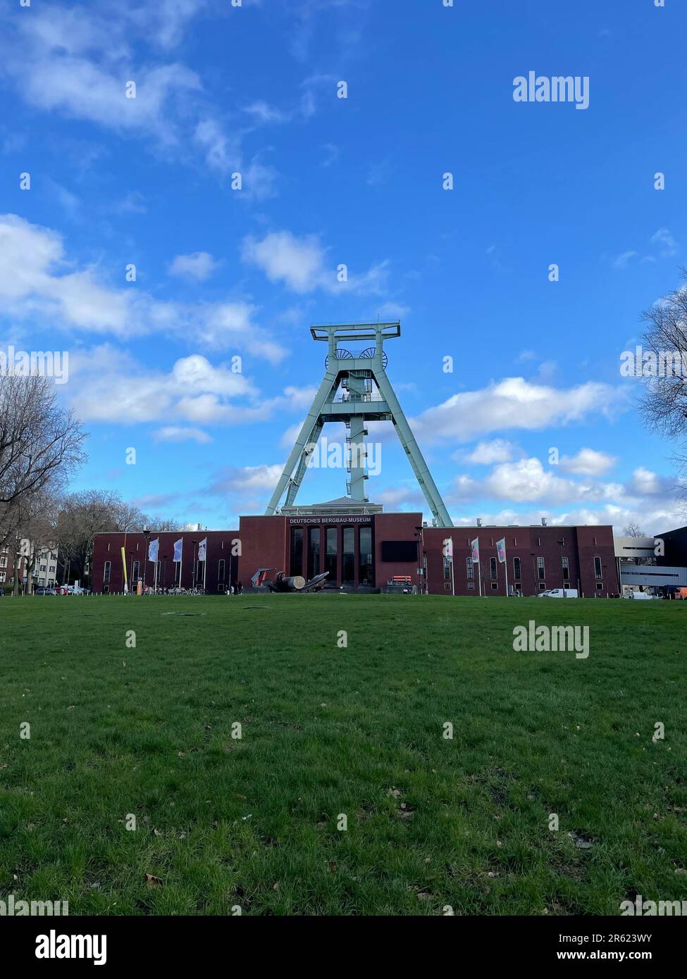 A scenic view of a park with a tall tower standing amidst lush green ...