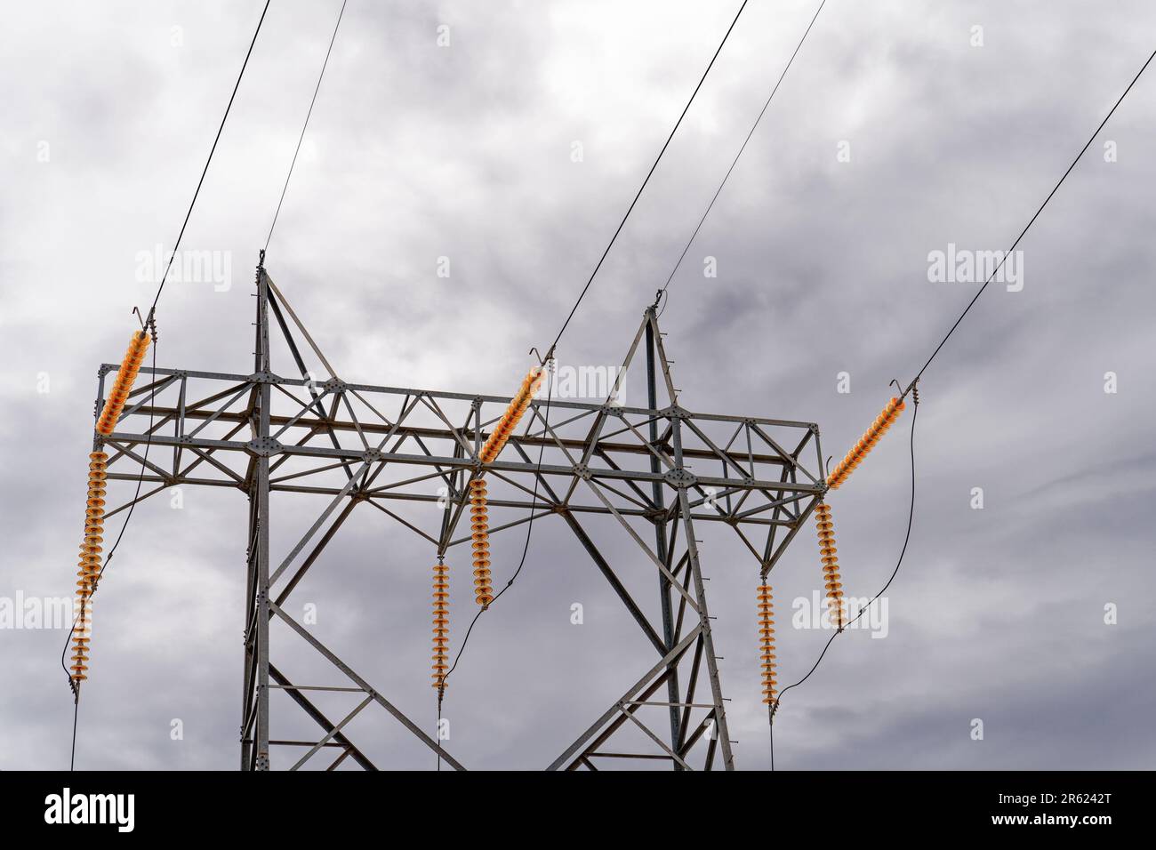 High voltage transmission tower or pylon with wires and many orange ...