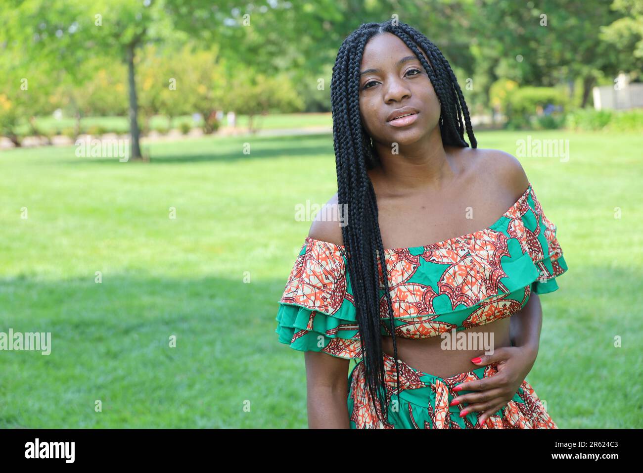 Beautiful Black lady posing in a park Stock Photo - Alamy
