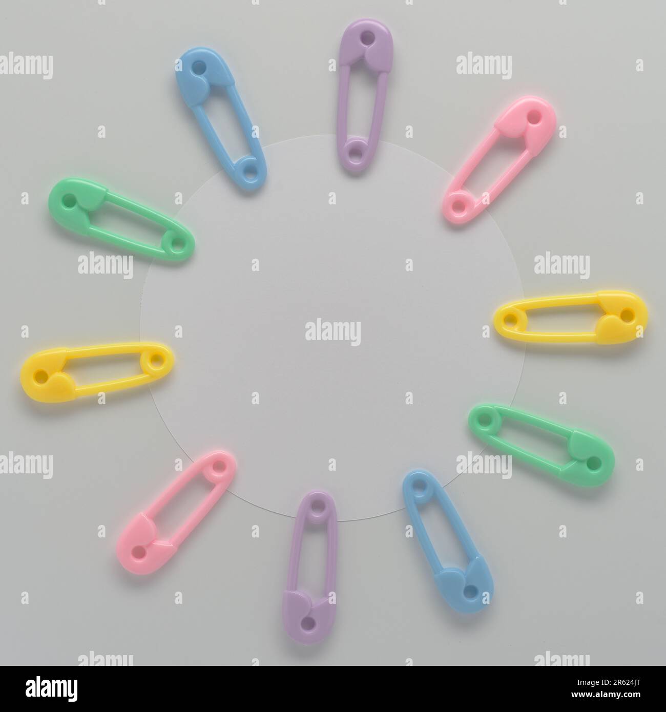 baby concept round white card on white background surrounded with multi ...