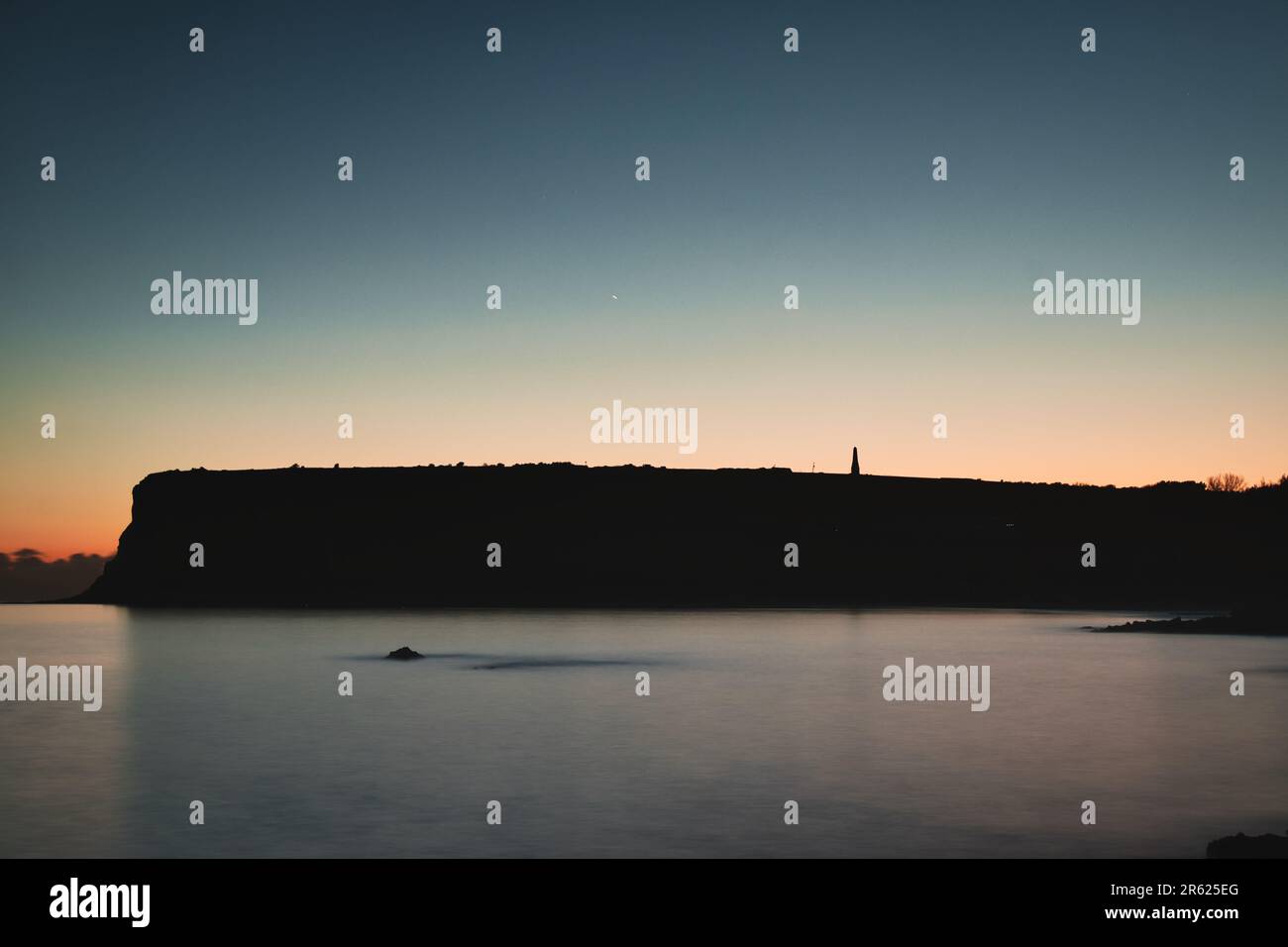A stunning nature landscape of a majestic cliff with a silhouetted ...