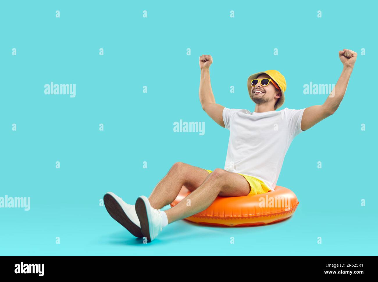 Funny guy on floating ring ready for summer Stock Photo - Alamy