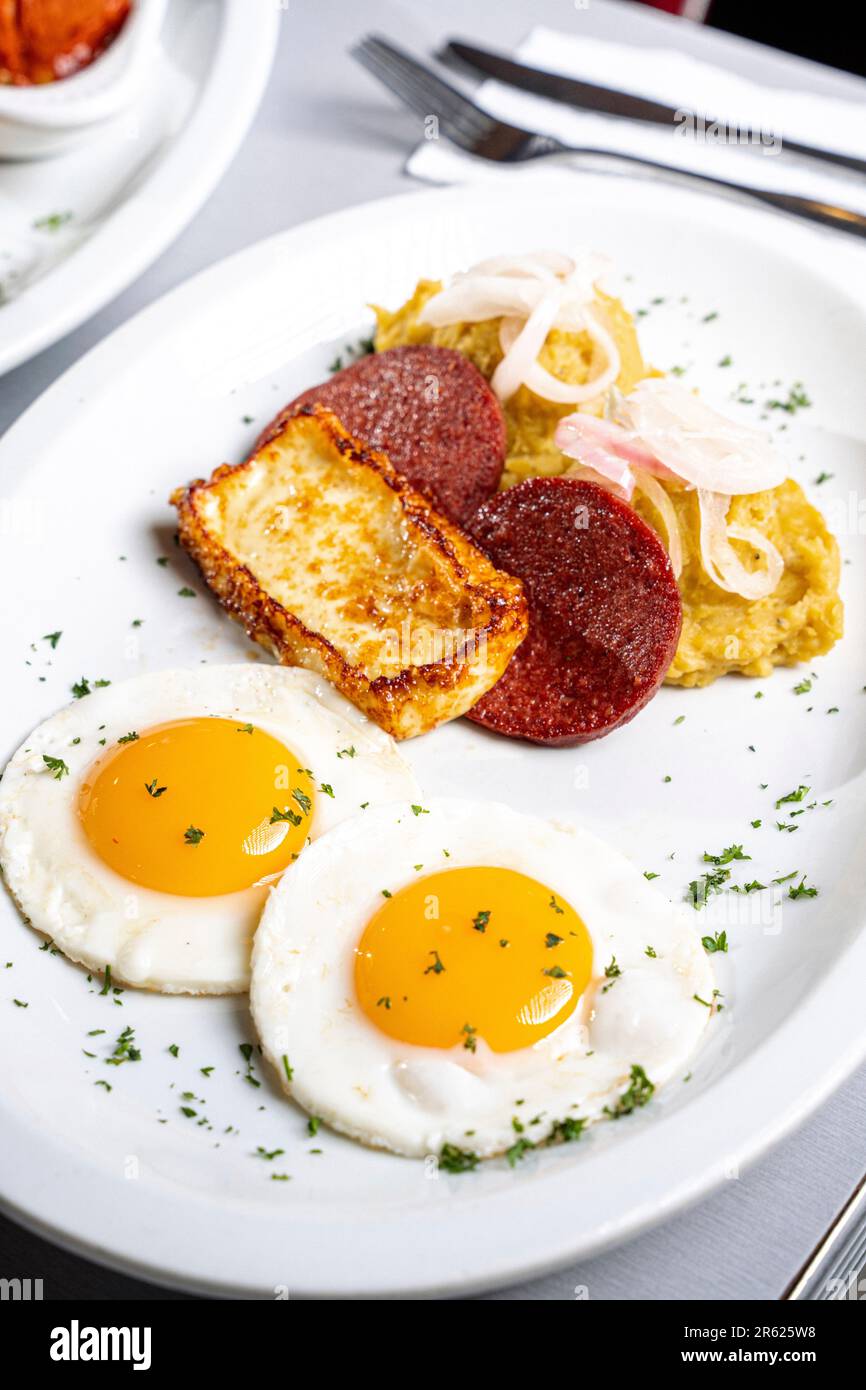 A close-up photograph of a traditional Dominican Mangu breakfast ...