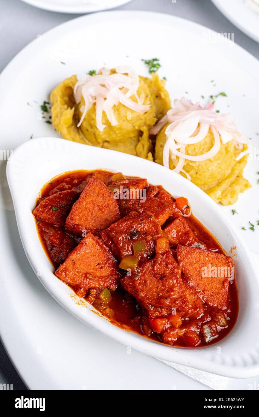 A plate of Mangu, a traditional Dominican breakfast food, served with ...