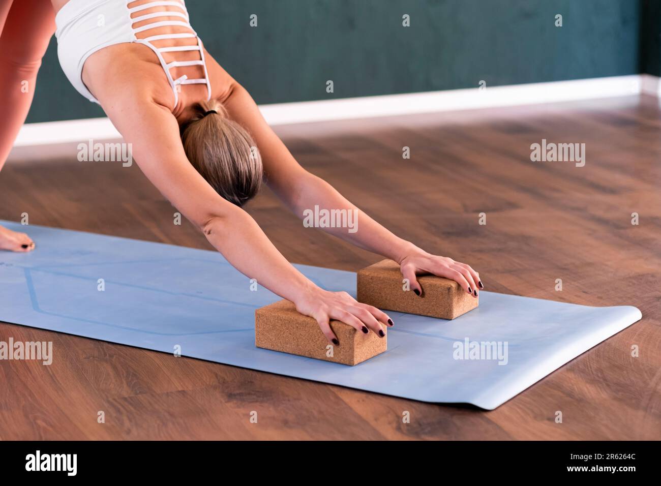 Professional yoga exercise flexible woman putting hands on special ...