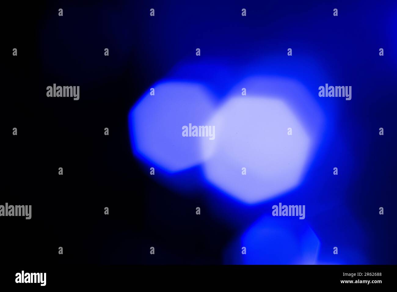 A vibrant nightscape with a backdrop of blurred blue and white lights ...