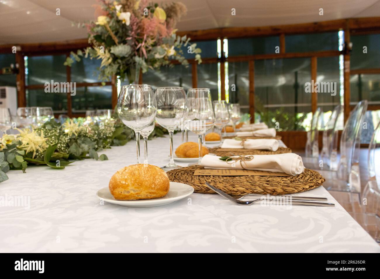 An array of vibrant white and yellow floral centerpieces arranged on a ...