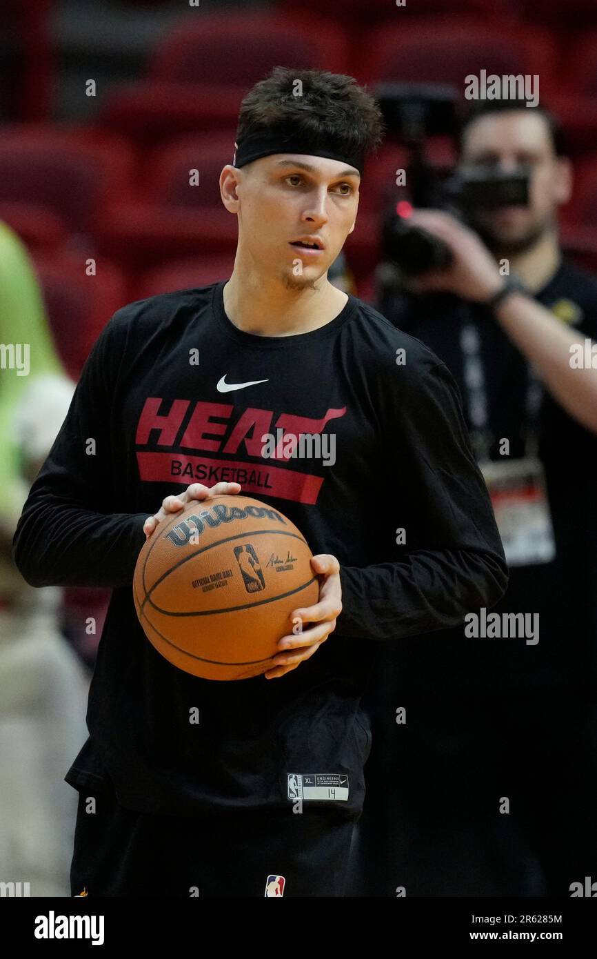 Miami Heat guard Tyler Herro carries a ball as he watches a team ...