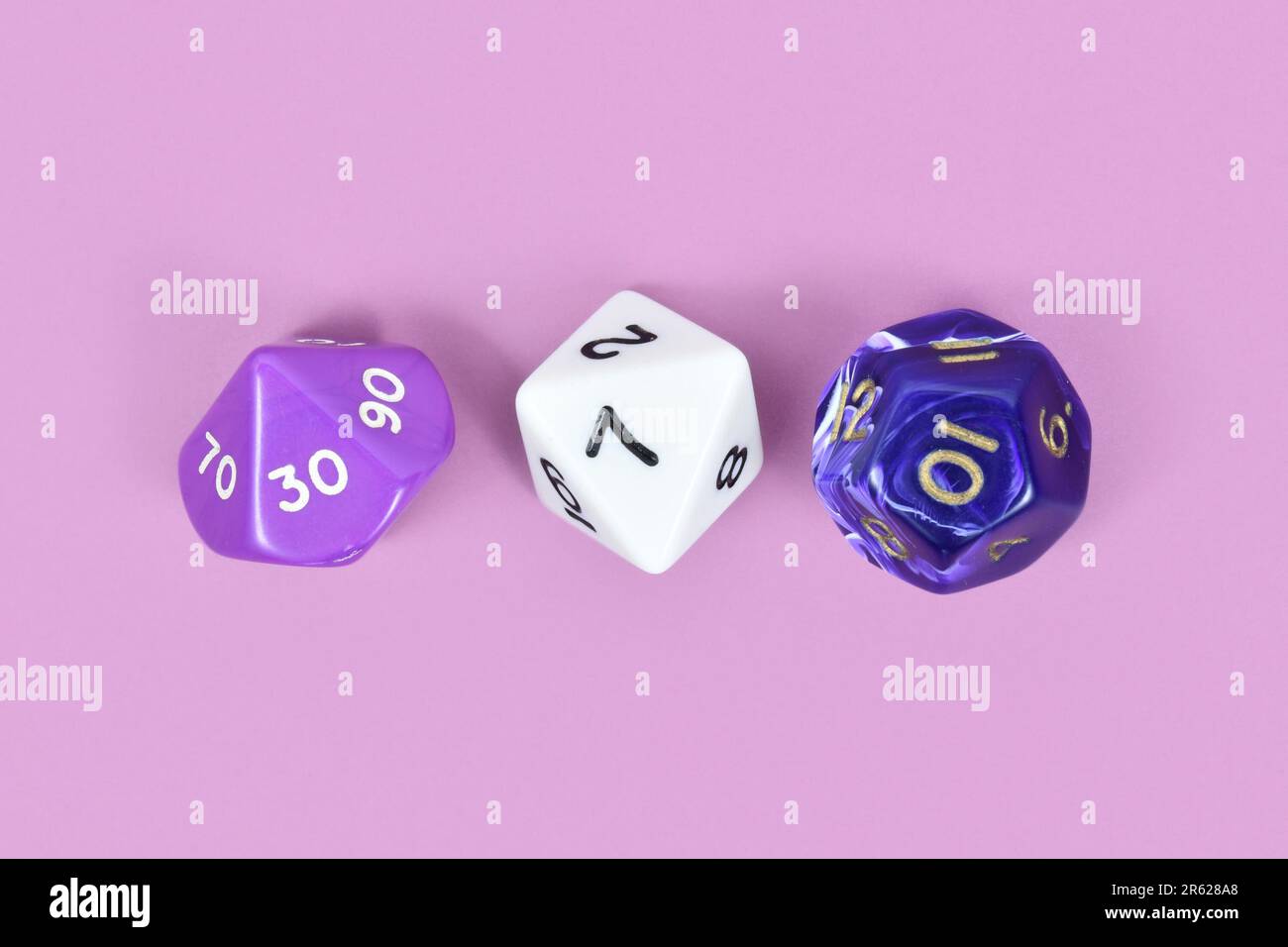 Three different roleplaying RPG dice on violet background Stock Photo ...