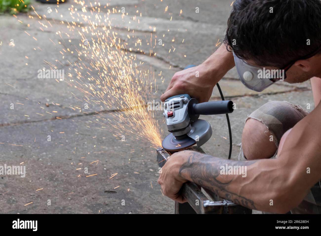 Grinder man in the middle of his job Stock Photo - Alamy