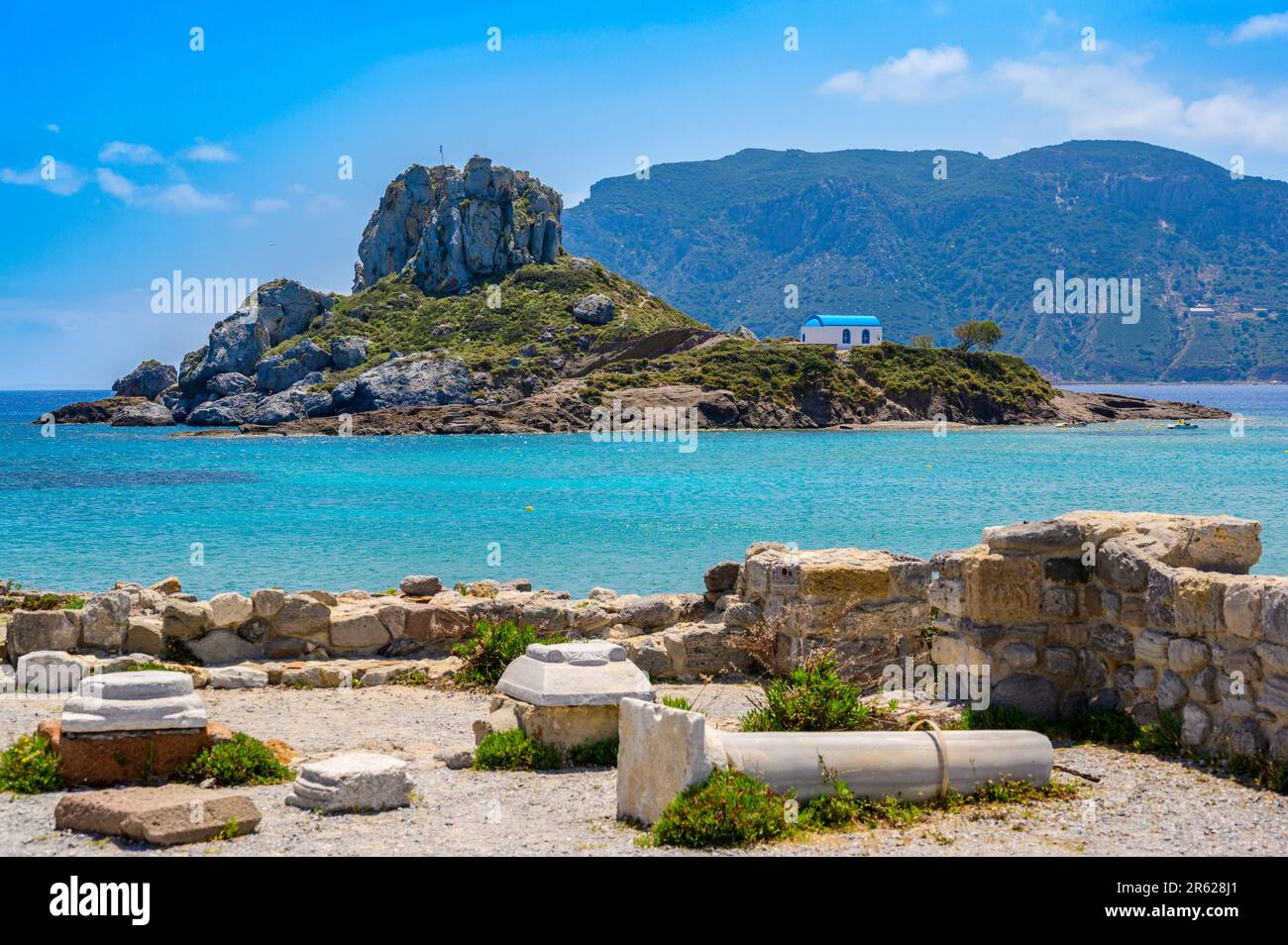 Ruins of the Basilica St. Stefanos in front of beautiful Island Kastri ...