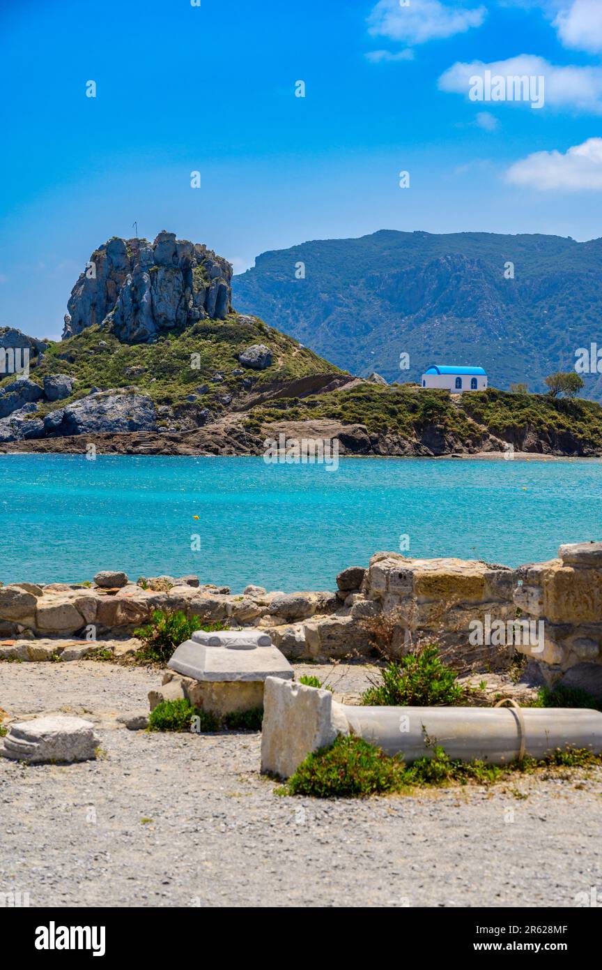Ruins of the Basilica St. Stefanos in front of beautiful Island Kastri ...