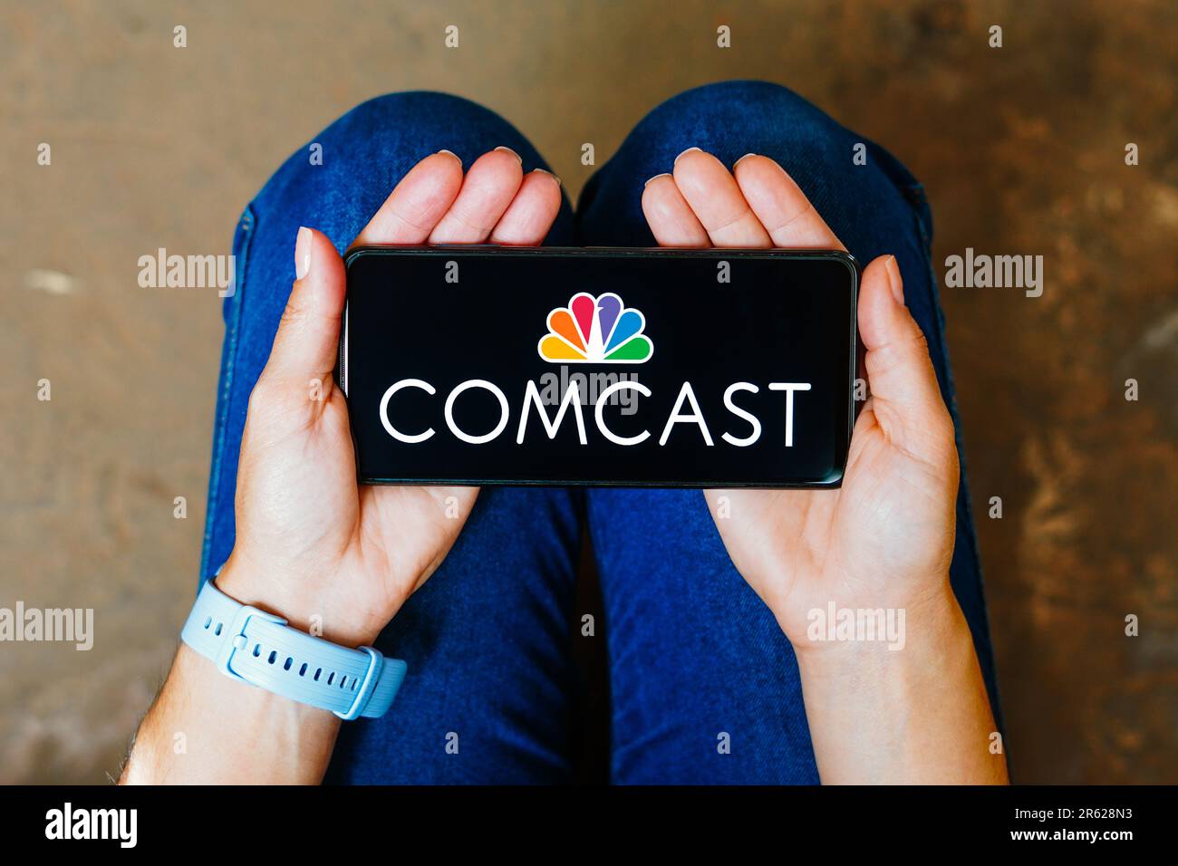 In this photo illustration, the Comcast Corporation logo is displayed ...