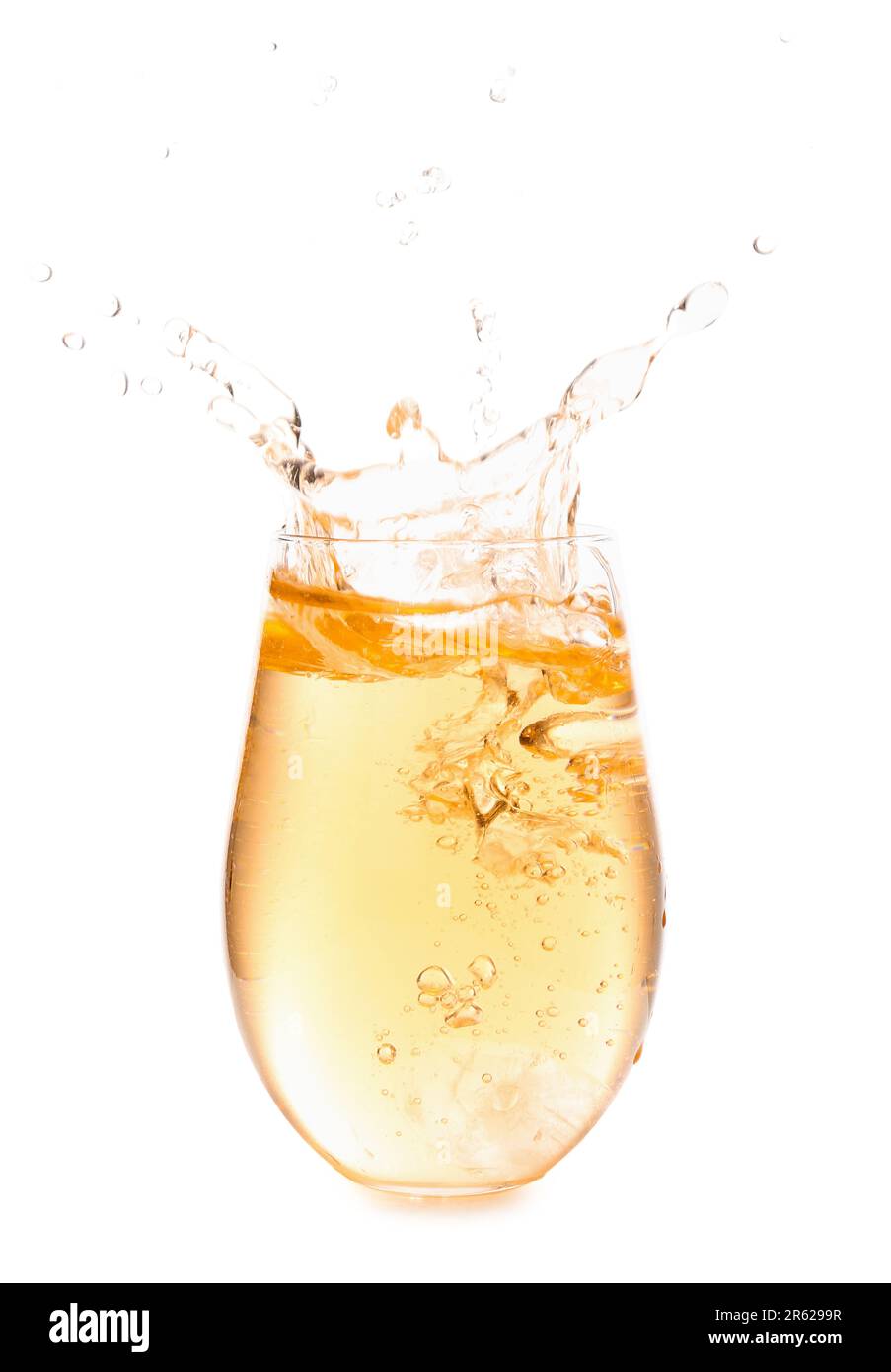 Glass of tasty apple cider with splashes and ice cube isolated on white ...