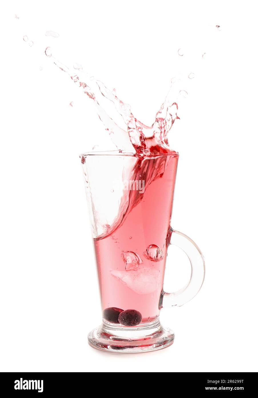 Glass of tasty blueberry cider with splashes, ice cube and berries ...