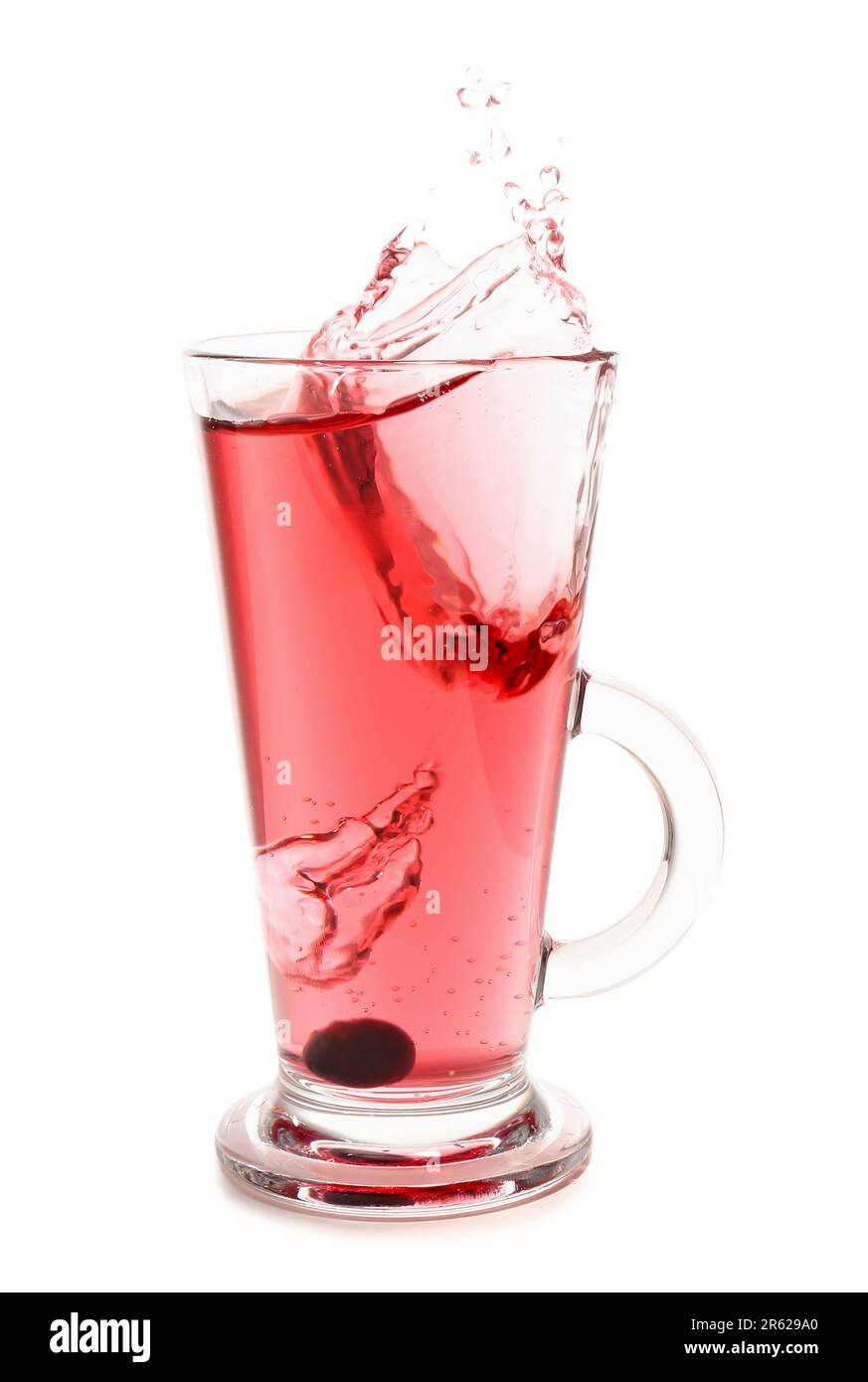 Glass of tasty blueberry cider with splashes, ice cube and berries ...