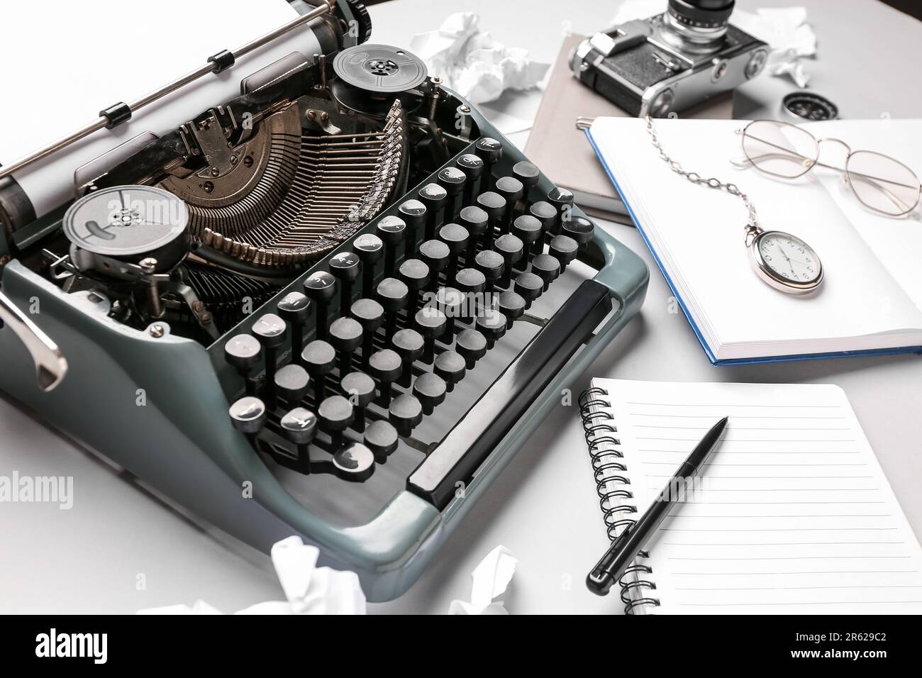 Composition with vintage typewriter, paper pieces, pocket watch and ...