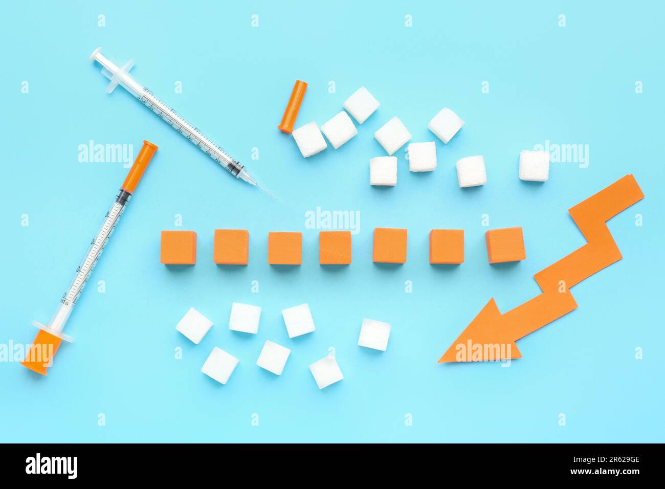 Word INSULIN with syringes, sugar and arrow directed downwards on blue ...