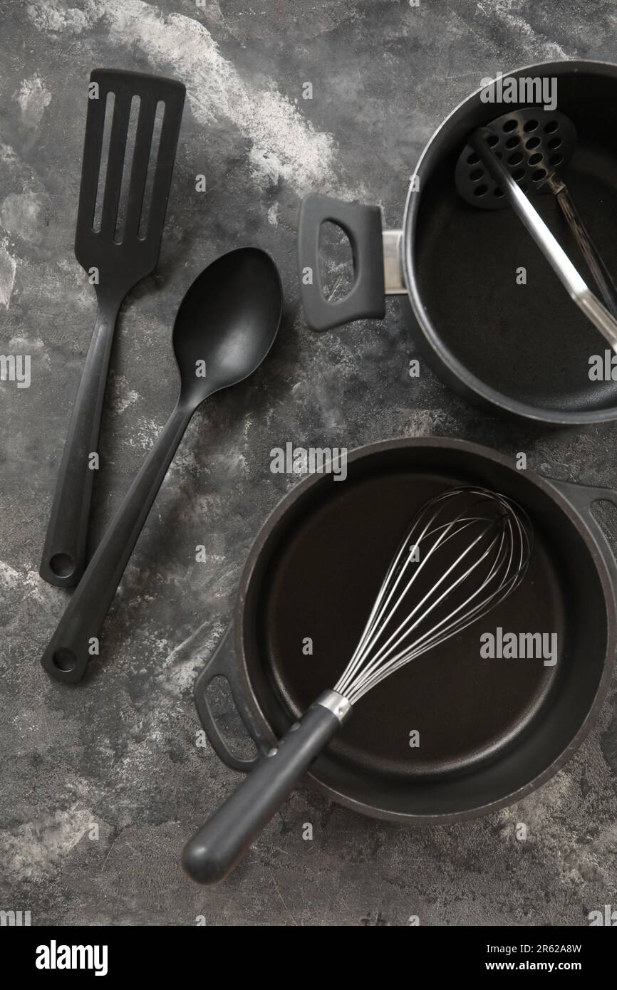 Cooking pots and kitchen utensils on dark grunge background Stock Photo ...