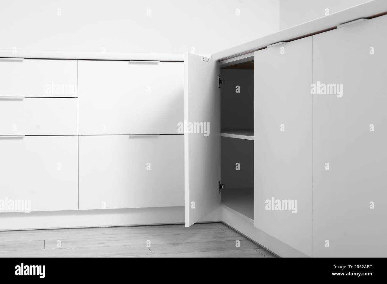 White counters with drawers in light kitchen Stock Photo - Alamy