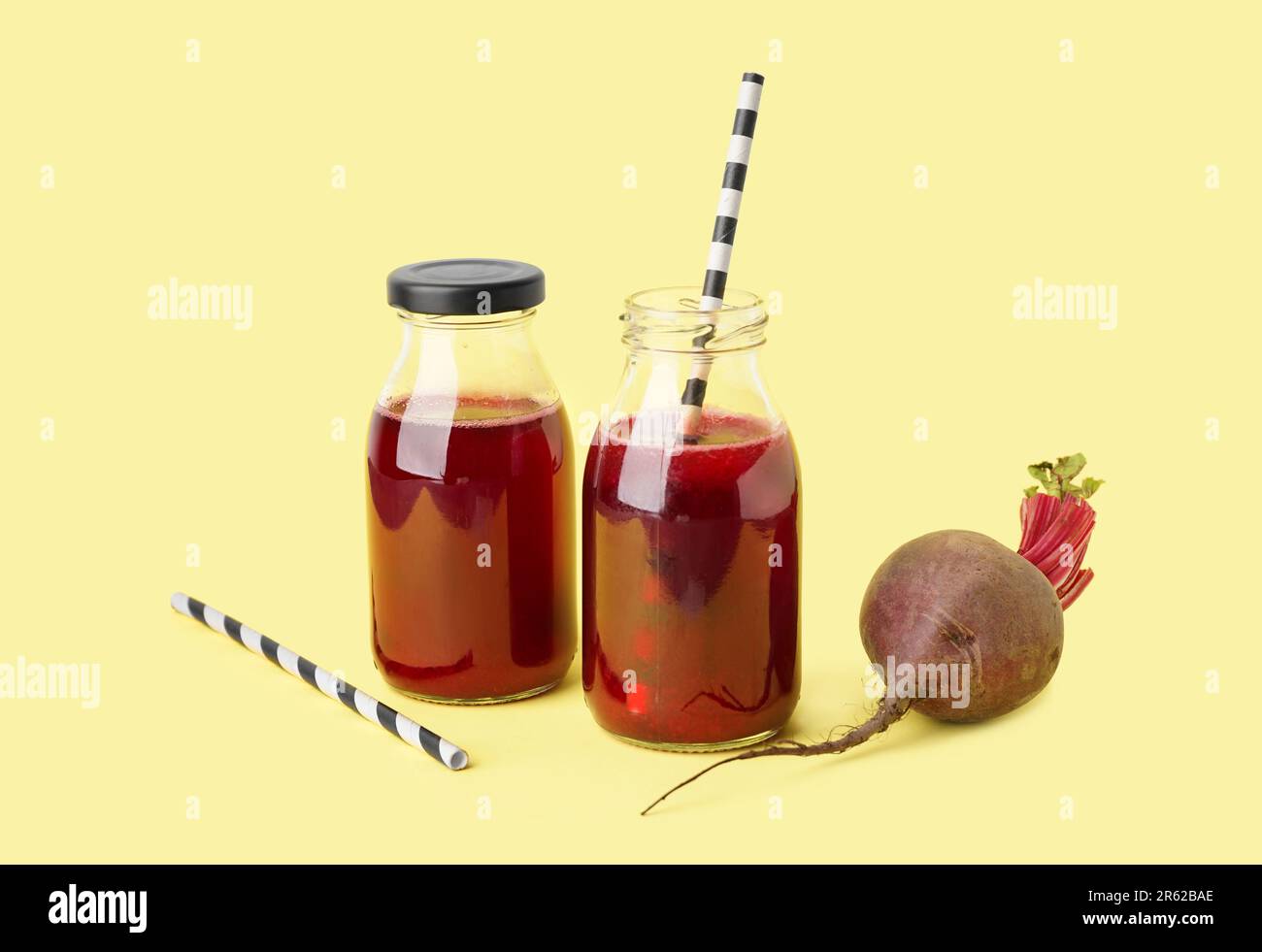 Bottles of healthy beet juice on yellow background Stock Photo - Alamy