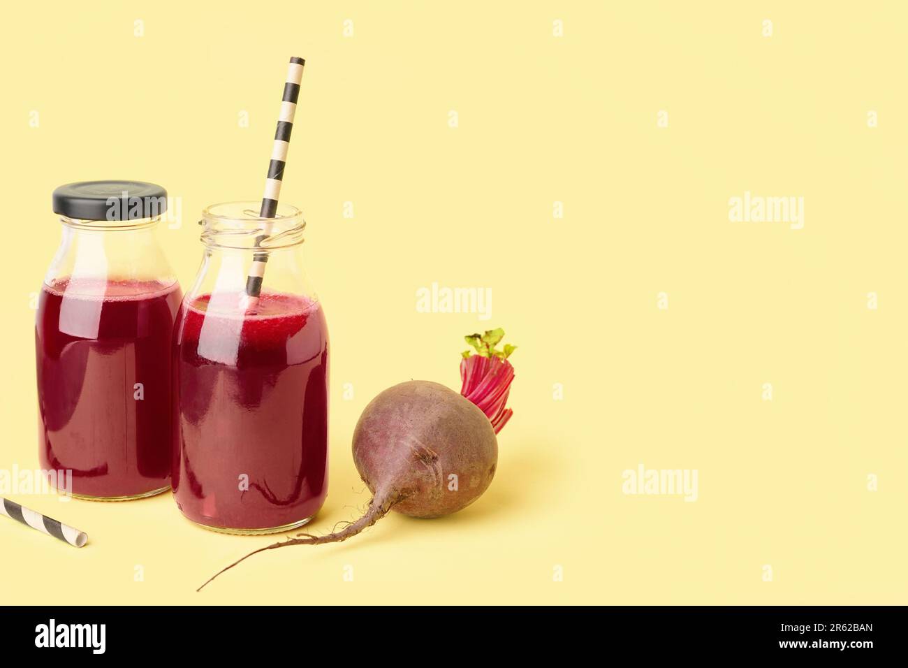 Bottles of healthy beet juice on yellow background Stock Photo - Alamy