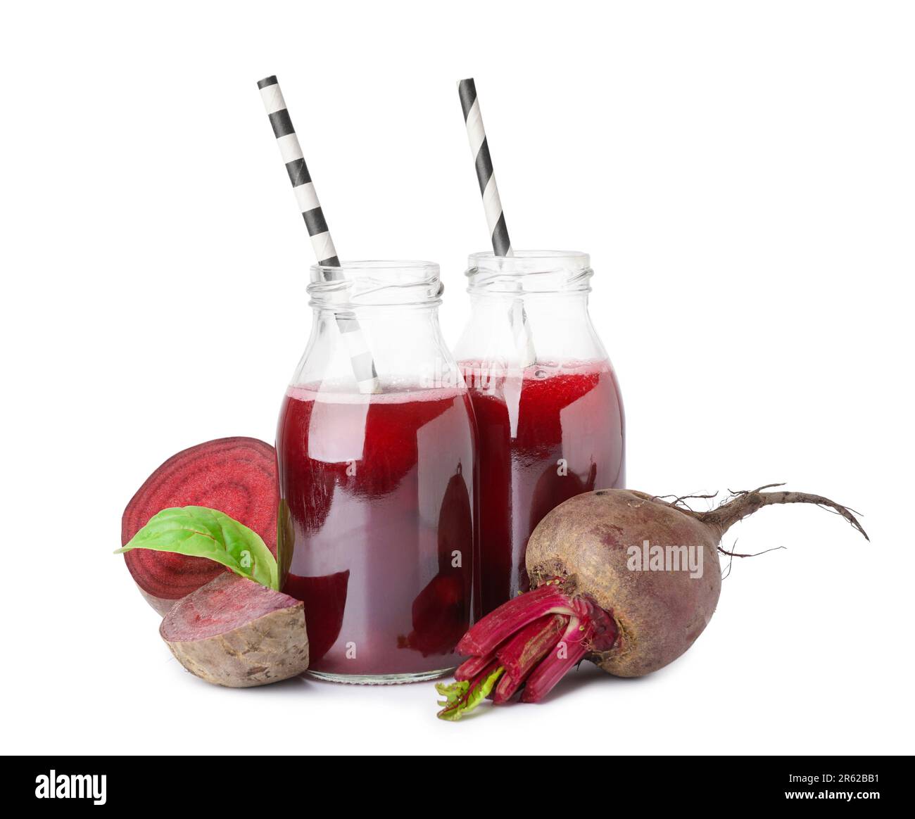 Bottles of healthy beet juice and spinach on white background Stock ...