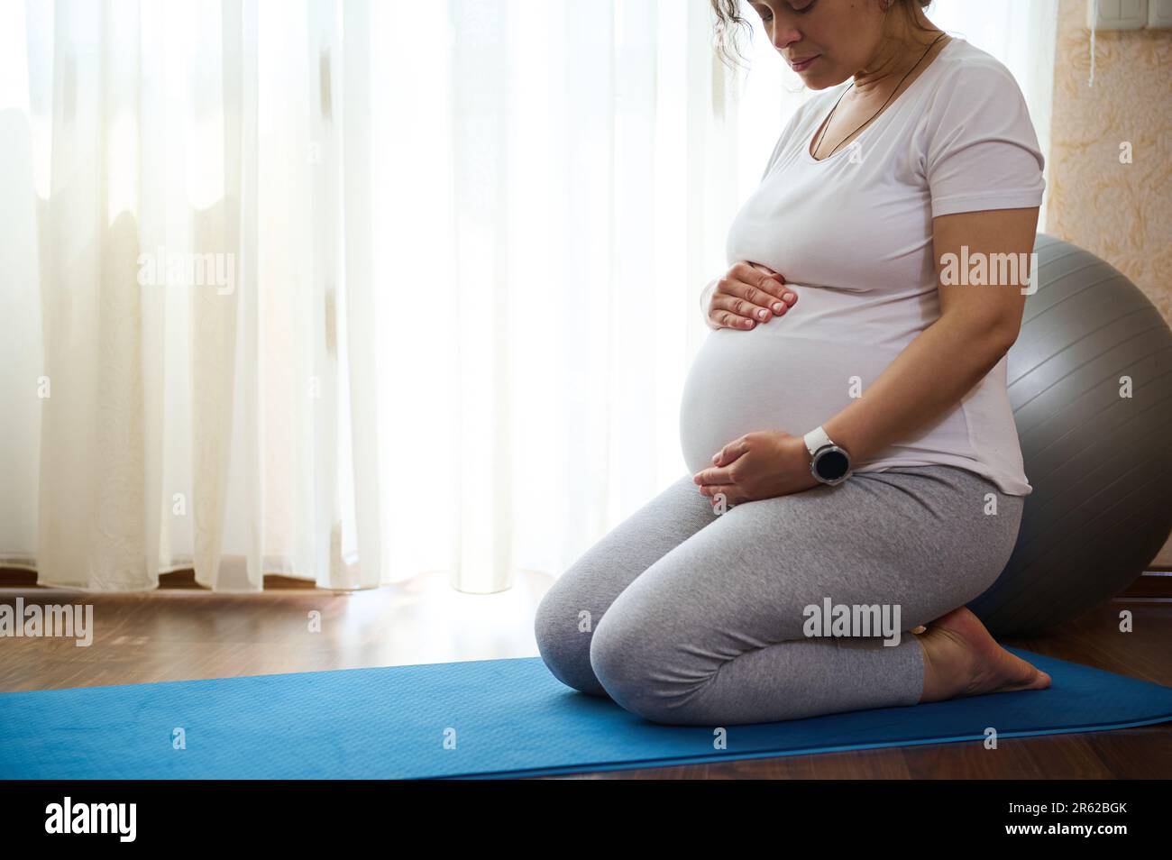 Pregnant woman in hero pose practicing prenatal breathing exercises for ...