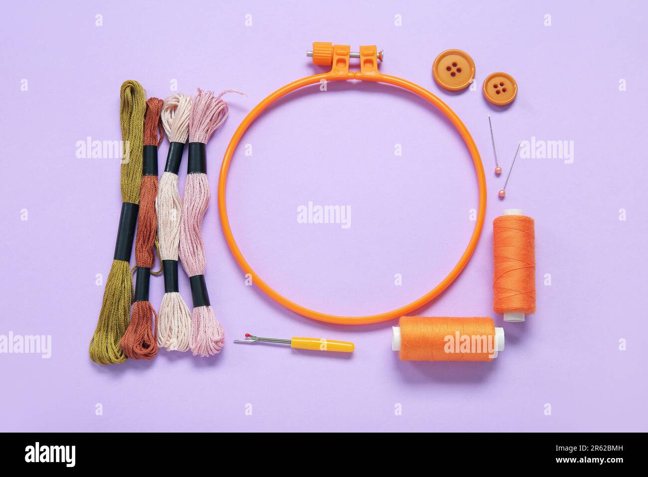 Embroidery hoop with different threads, seam ripper and buttons on ...