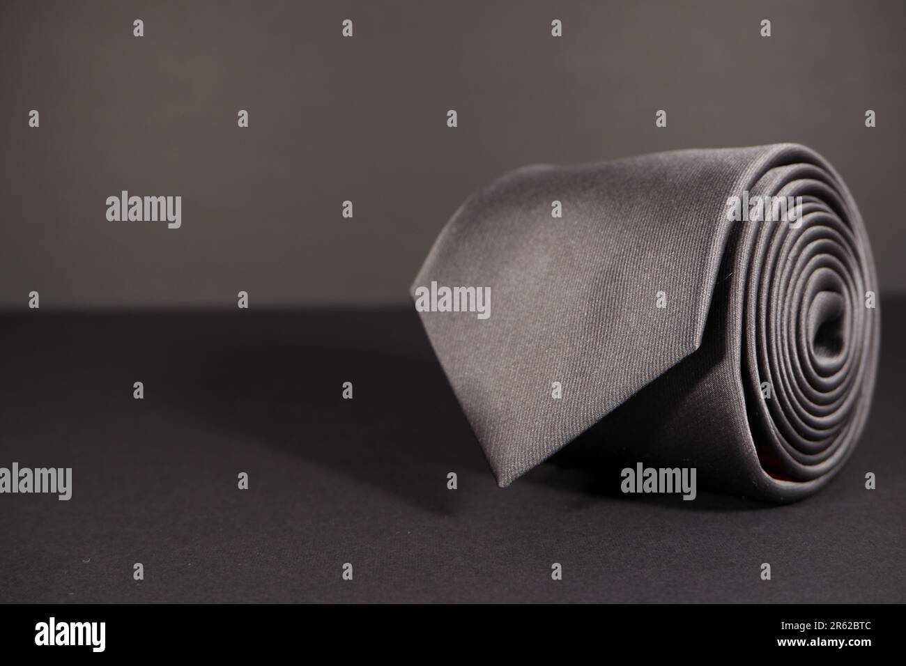 This is a high-quality stock photo of a black satin tie featuring two ...