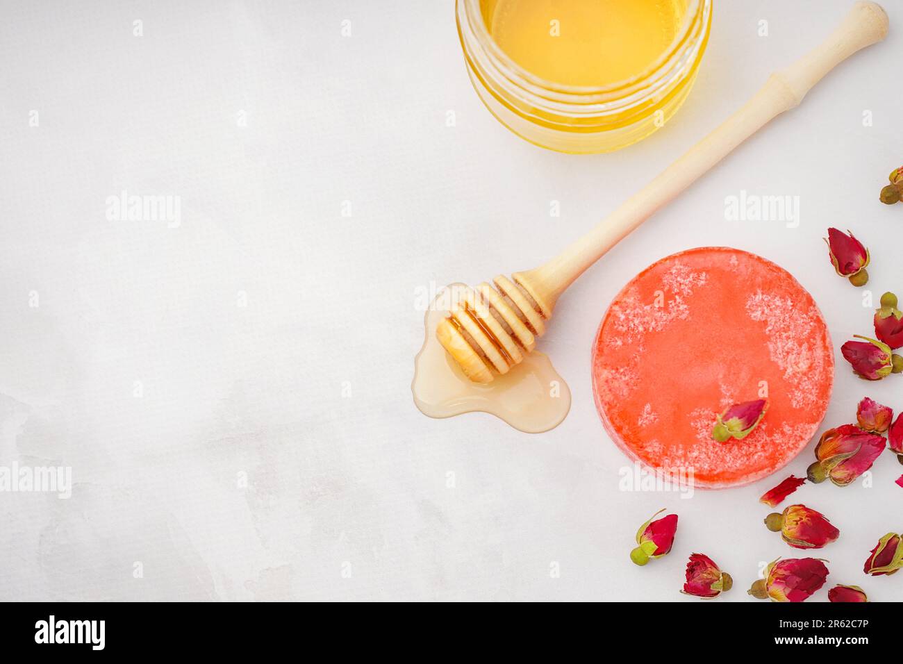 Handmade solid shampoo with honey and dry flowers on light background ...