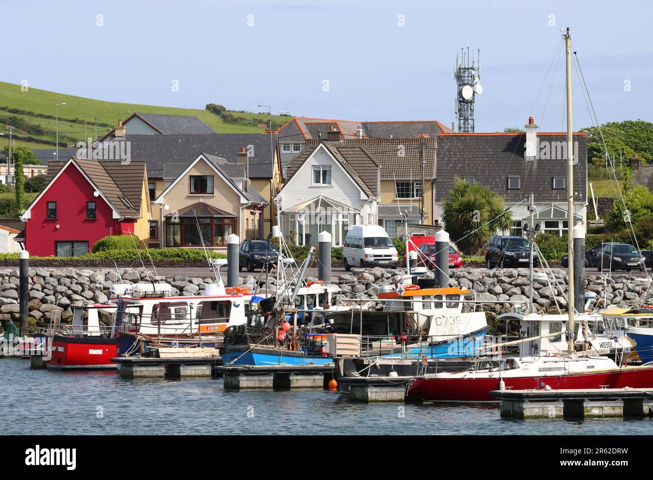 Colorful houses and boats lining Dingle Harbour in Dingle, Ireland ...