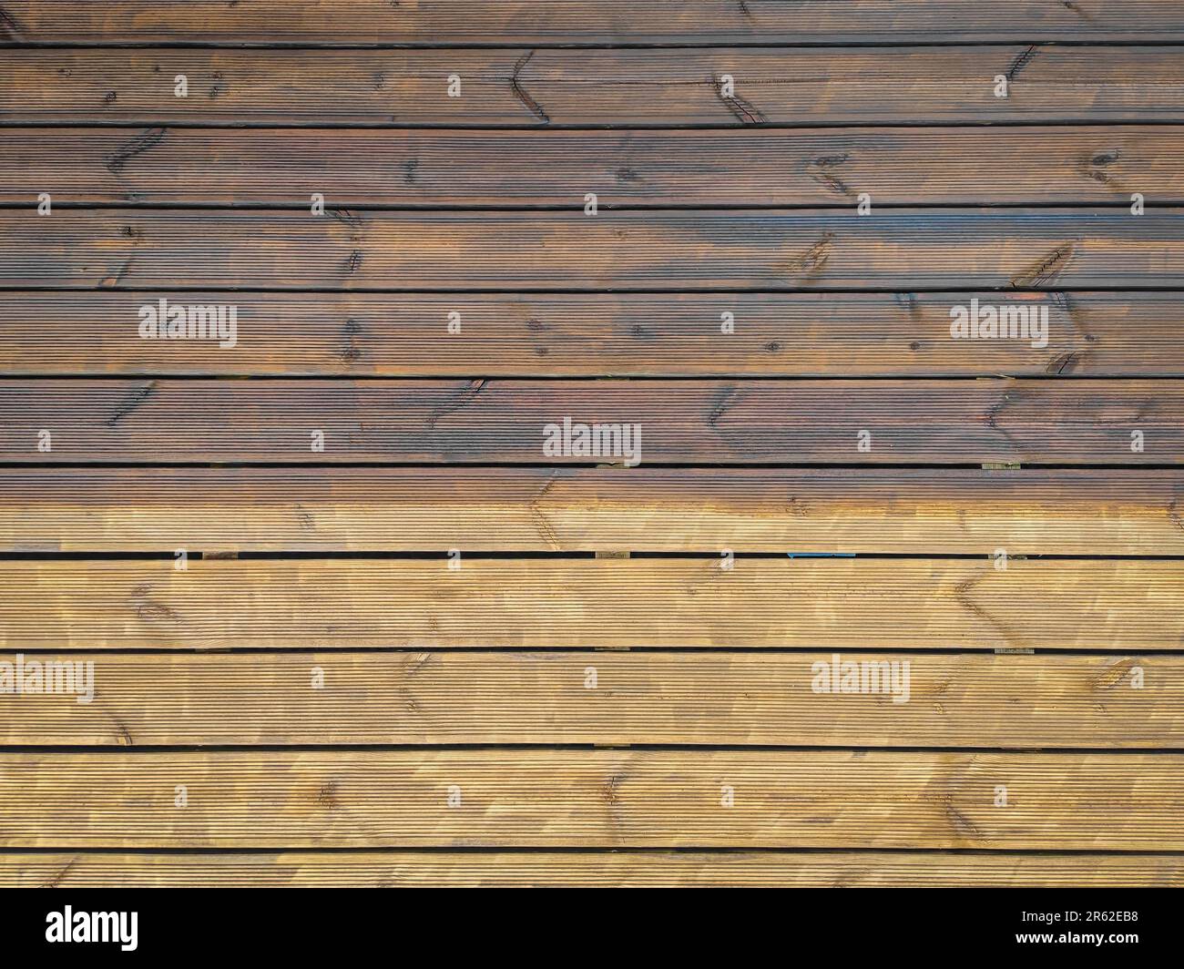 Partially painted and partly cleaned fluted wood terrace impregnated ...