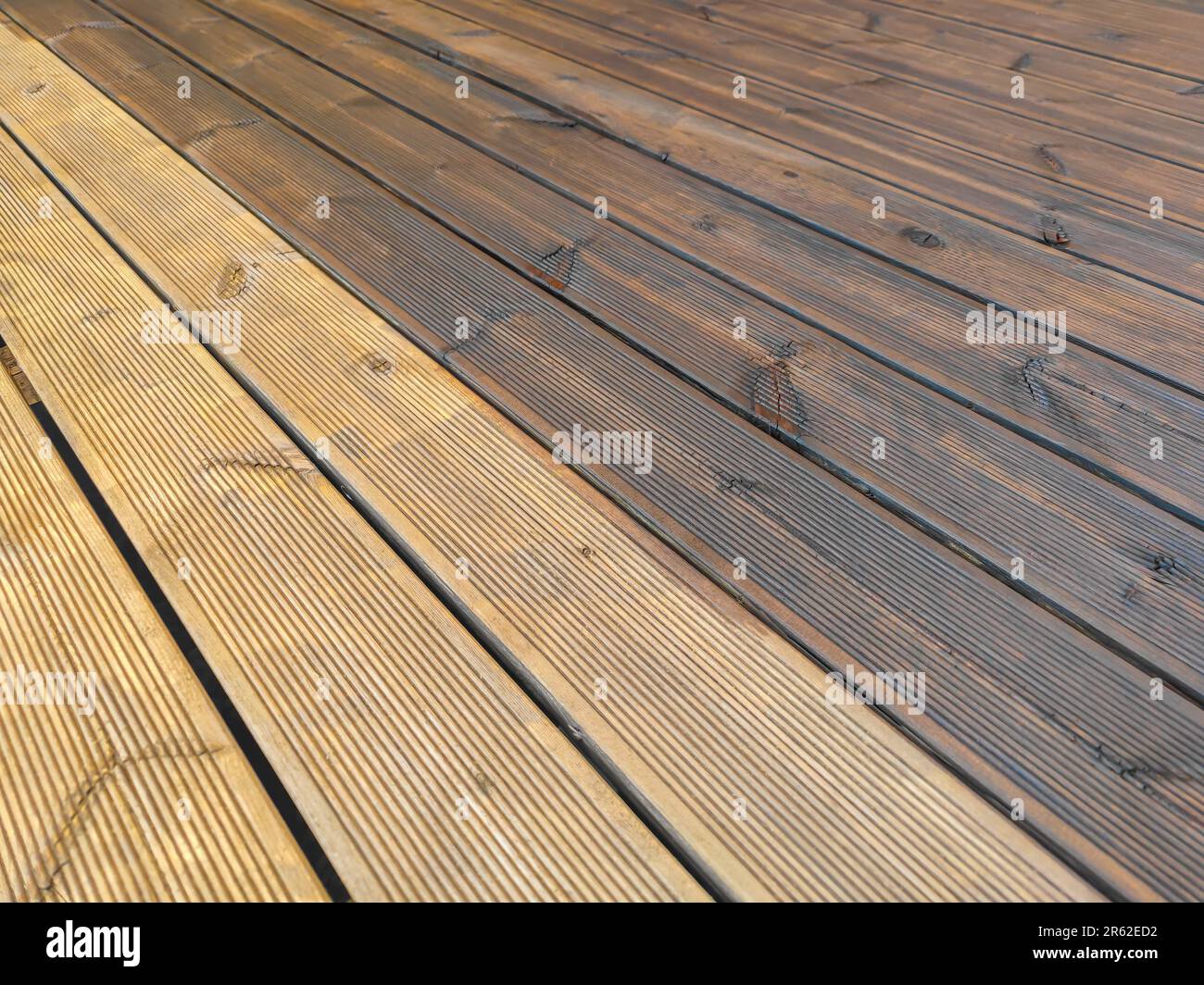 Partially painted and partly cleaned fluted wood terrace impregnated ...