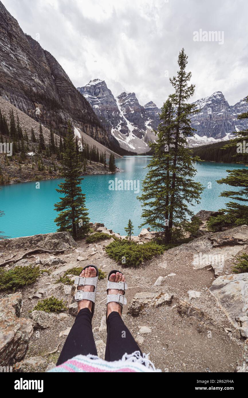 Moraine Lake in Banff National Park on an overcast day, with a woman ...
