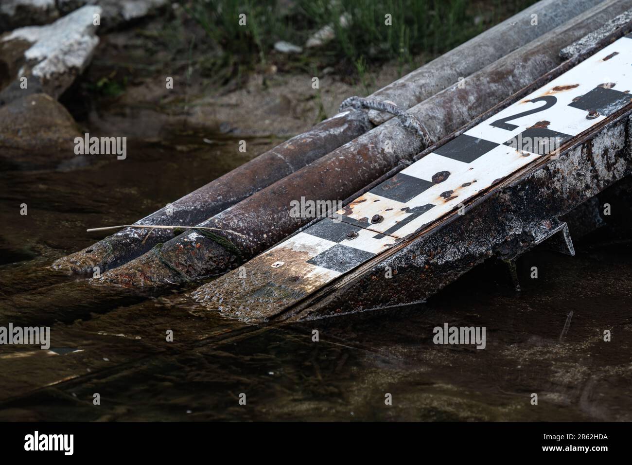 Depth scale at shore of river to measure water level, which is very low ...