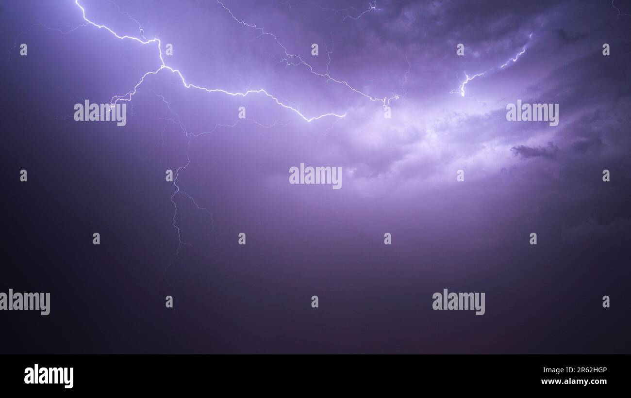 A stunning image of a night sky illuminated by two powerful lightning ...