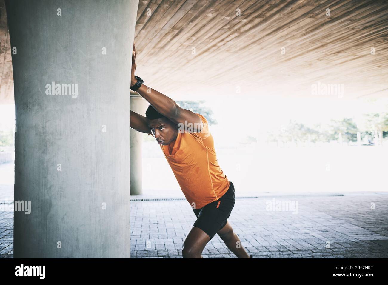 Miracles dont make muscle, discipline does. a young man stretching ...
