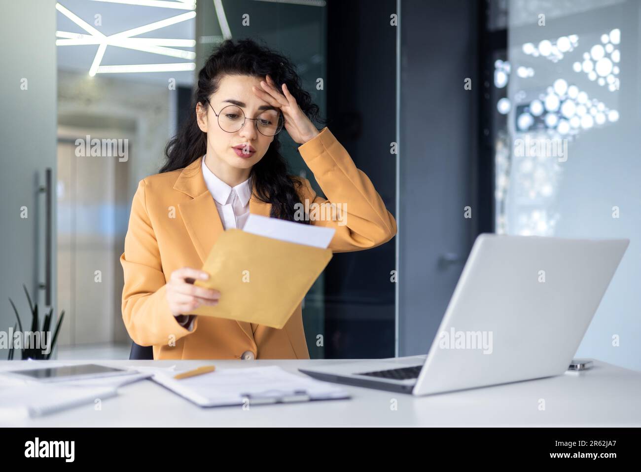 Dissatisfied and upset businesswoman received letter in envelope ...