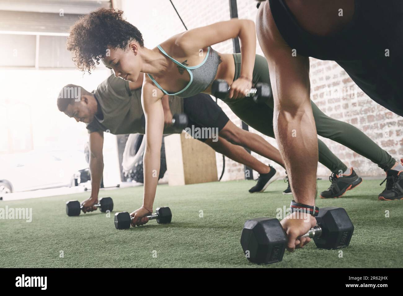 We play hard but work even harder. a fitness group using dumbbells ...