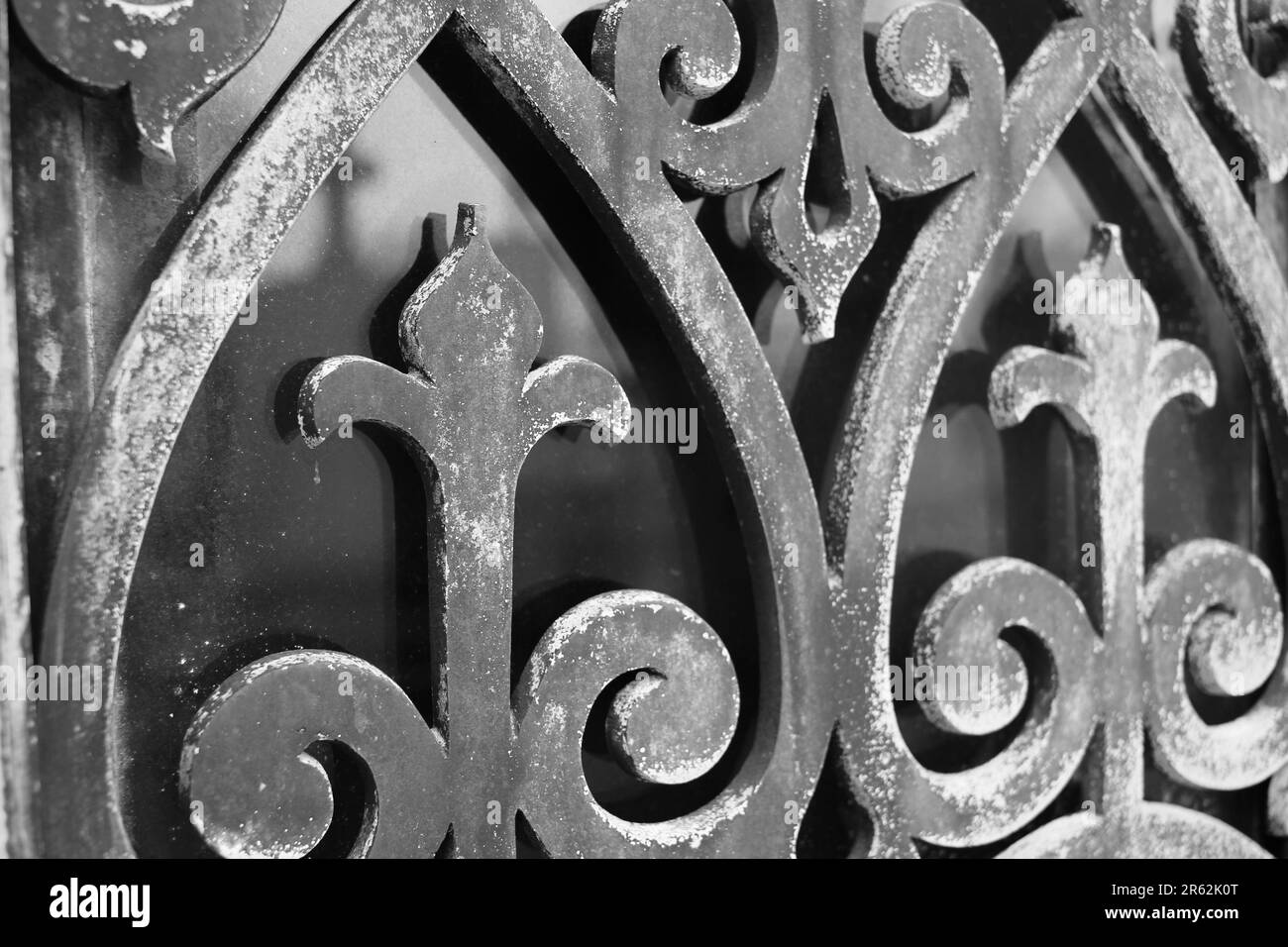 A decorative copper metal fence with a fleur de lis grid pattern in a ...